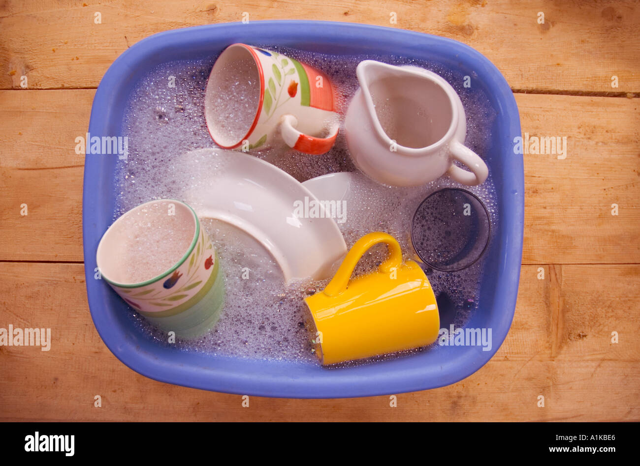 blue washing up bowl with crockery Stock Photo - Alamy
