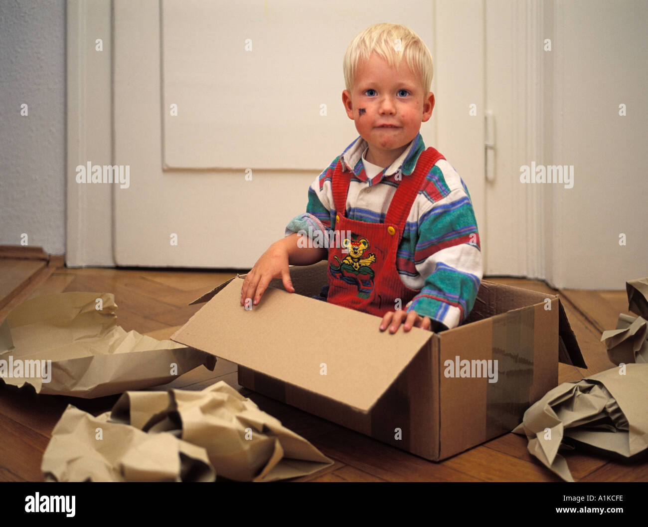 Two year old boy in a box MR Stock Photo - Alamy