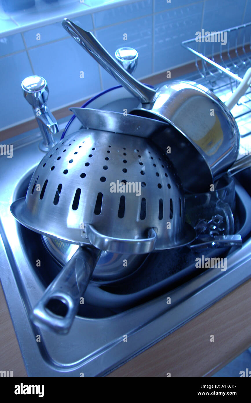 A sink full of pots and pans ready for washing up Stock Photo - Alamy