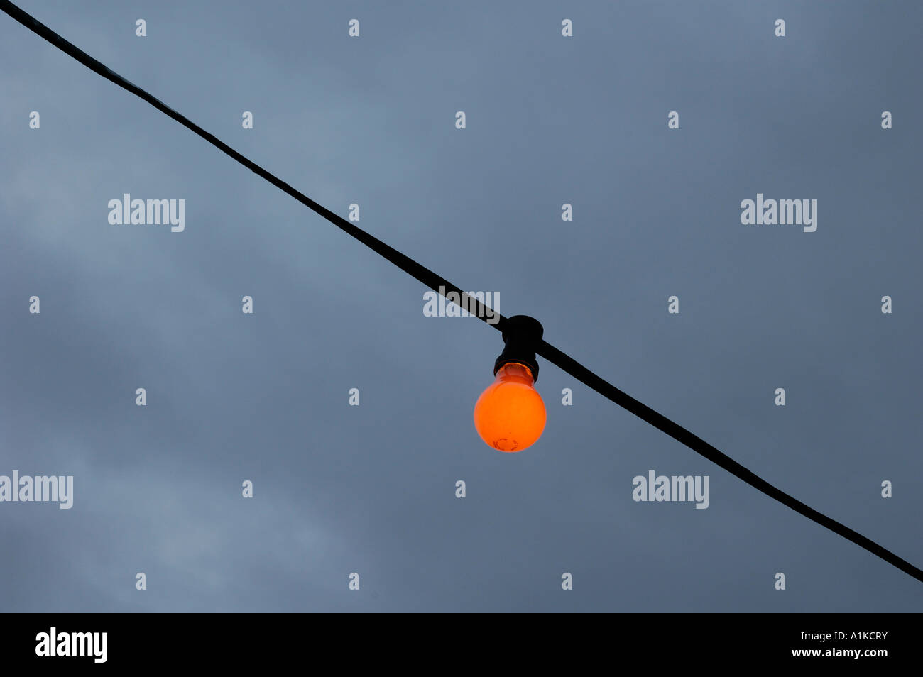 Orange light bulb Stock Photo - Alamy