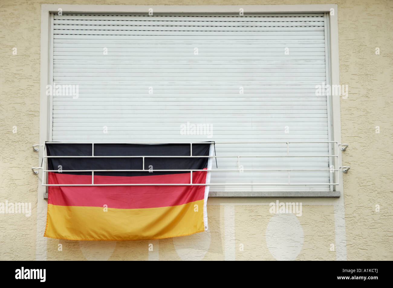Germany national flag hanging in front of a window Stock Photo - Alamy