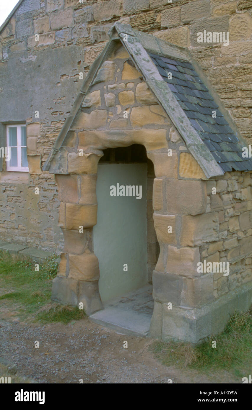 Sandstone wall eroded by wind blown sand, Northumberland coast, England ...