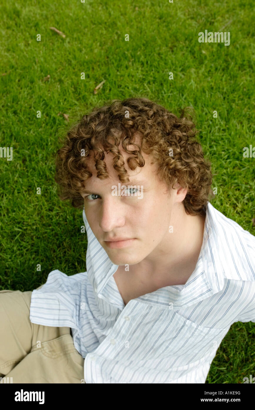 Young man with curly hair outdoors, portrait Stock Photo - Alamy