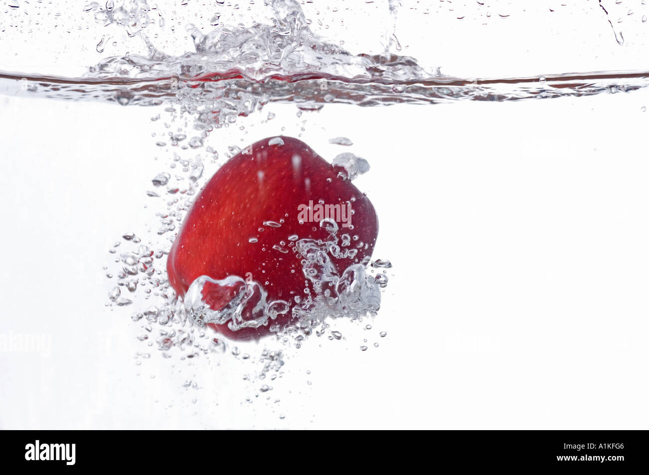 apple fruit dropped into water making splash Stock Photo - Alamy