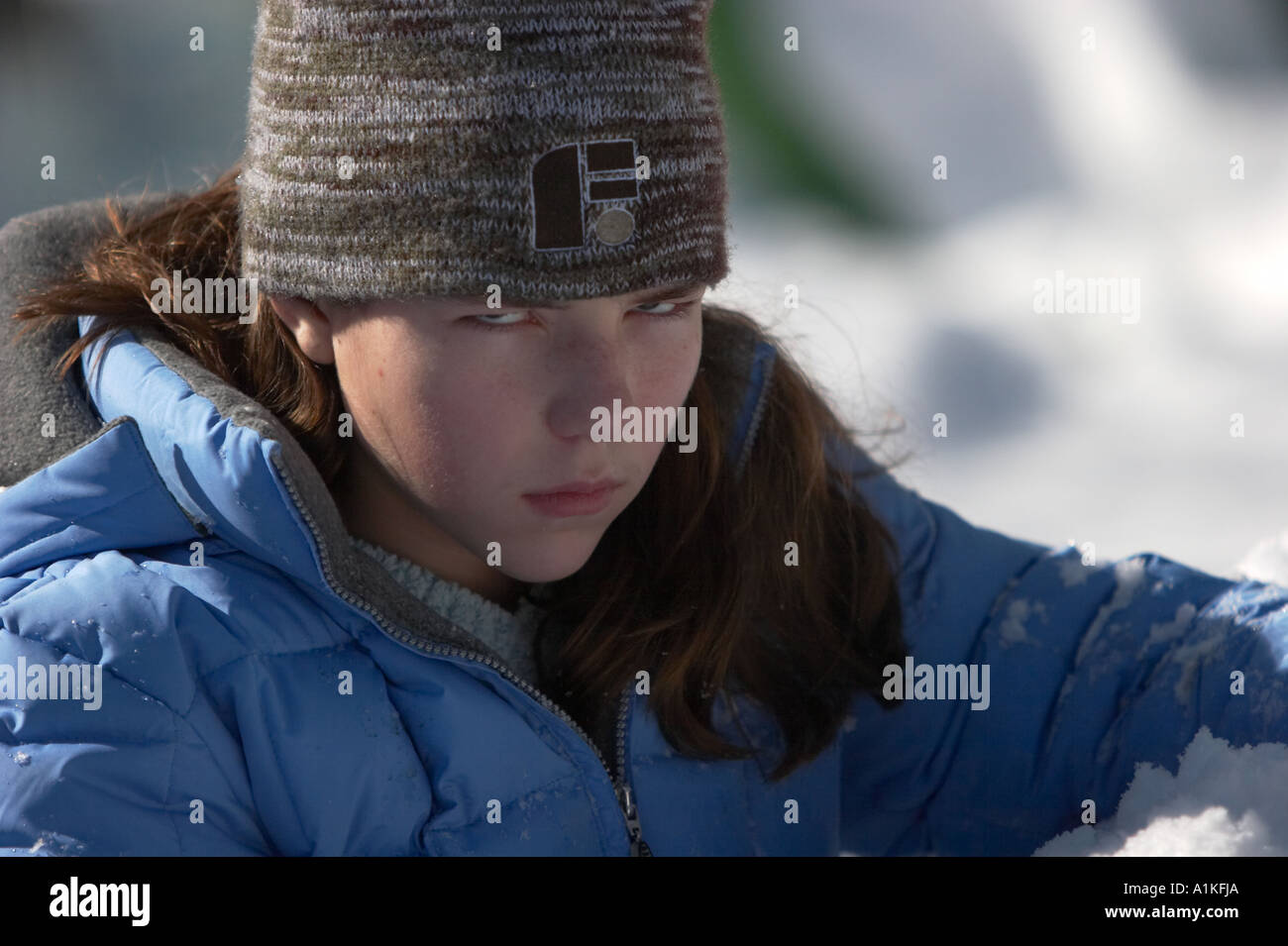 A young teenage girl in the snow with a sour expression Stock Photo - Alamy