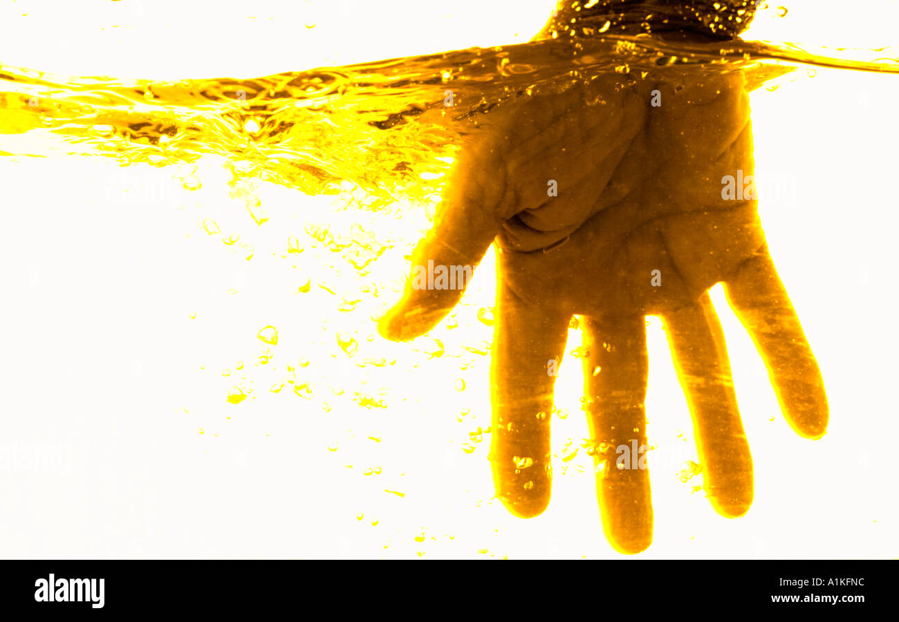 hand dipping into water making splash and bubbles Stock Photo - Alamy