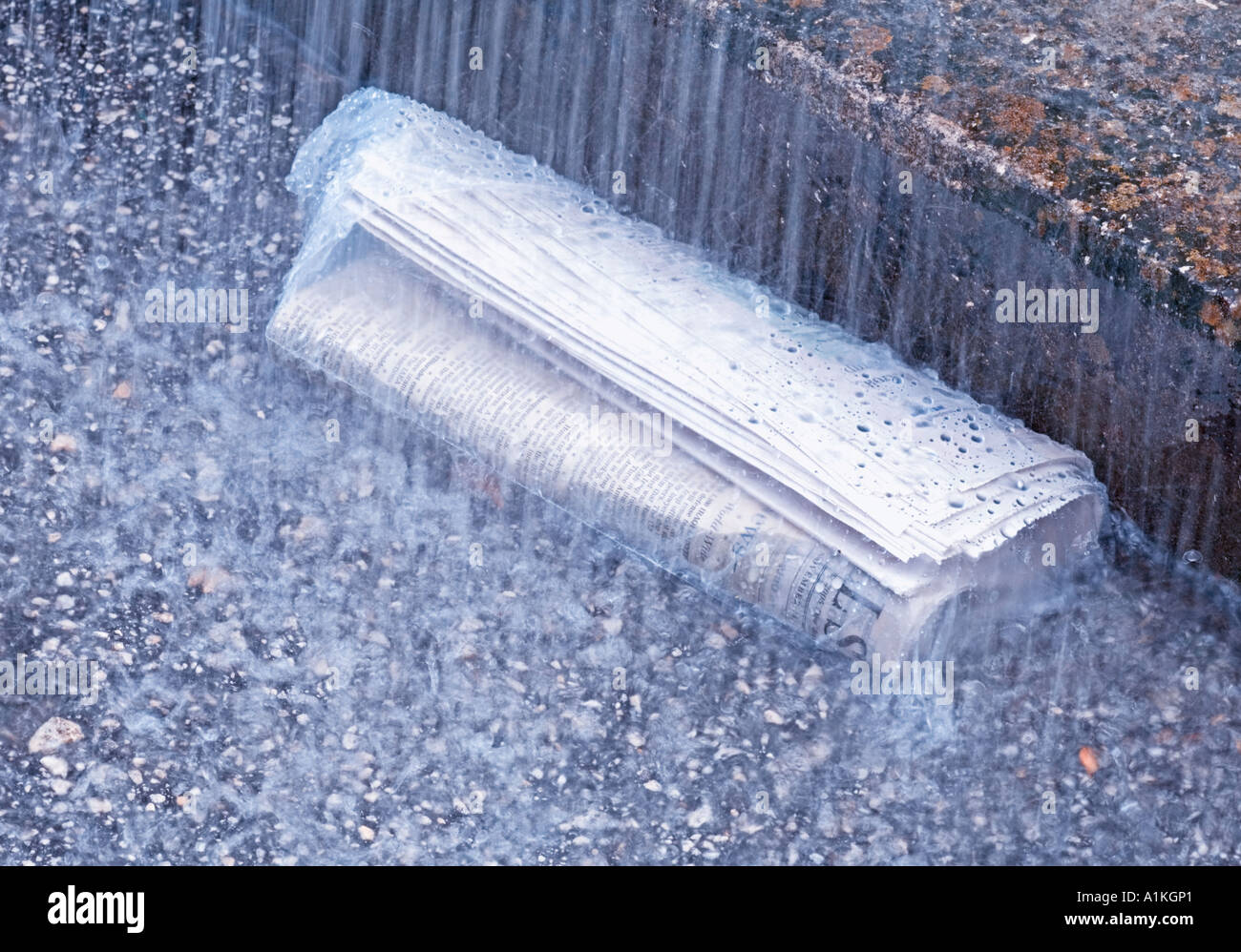 rain soaked morning newspaper in street during rain Stock Photo - Alamy