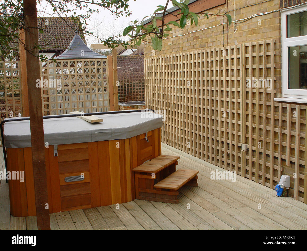 Timber deck with trellis and hot tub spa Stock Photo - Alamy