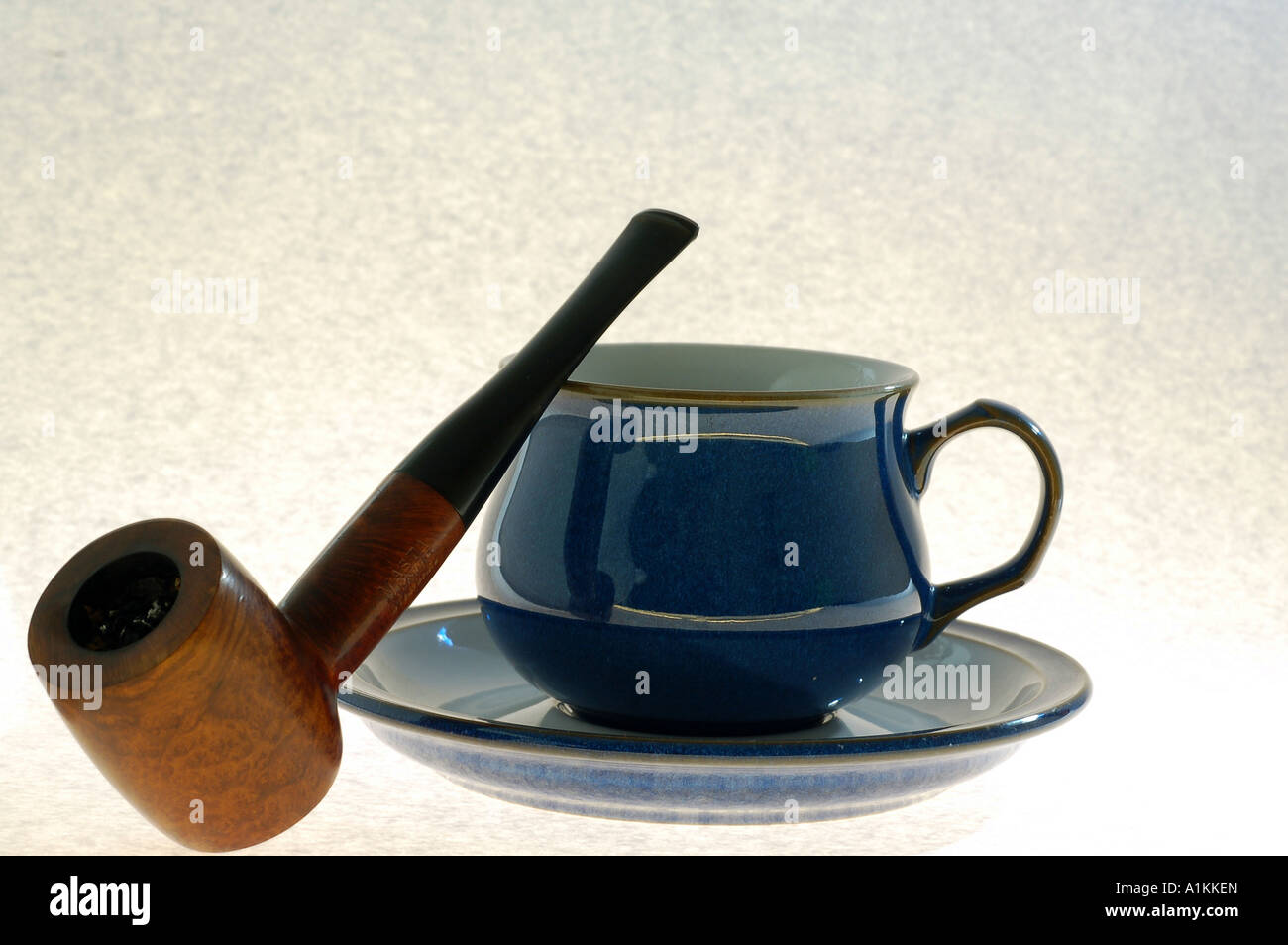 still life Old wooden pipe and a cup of coffee on white background ...