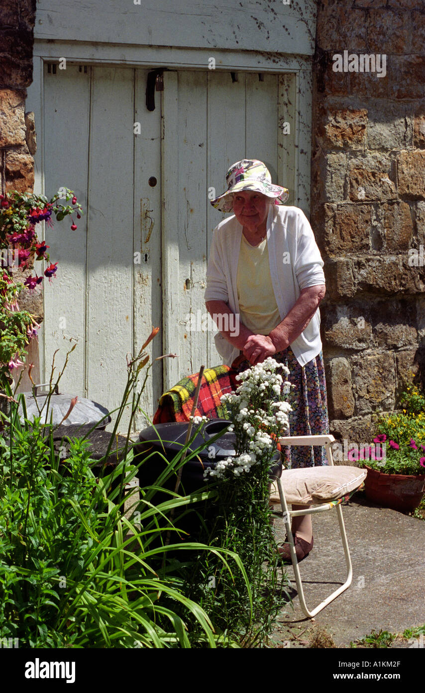Elderly lady outside in her garden, Kent UK Stock Photo - Alamy