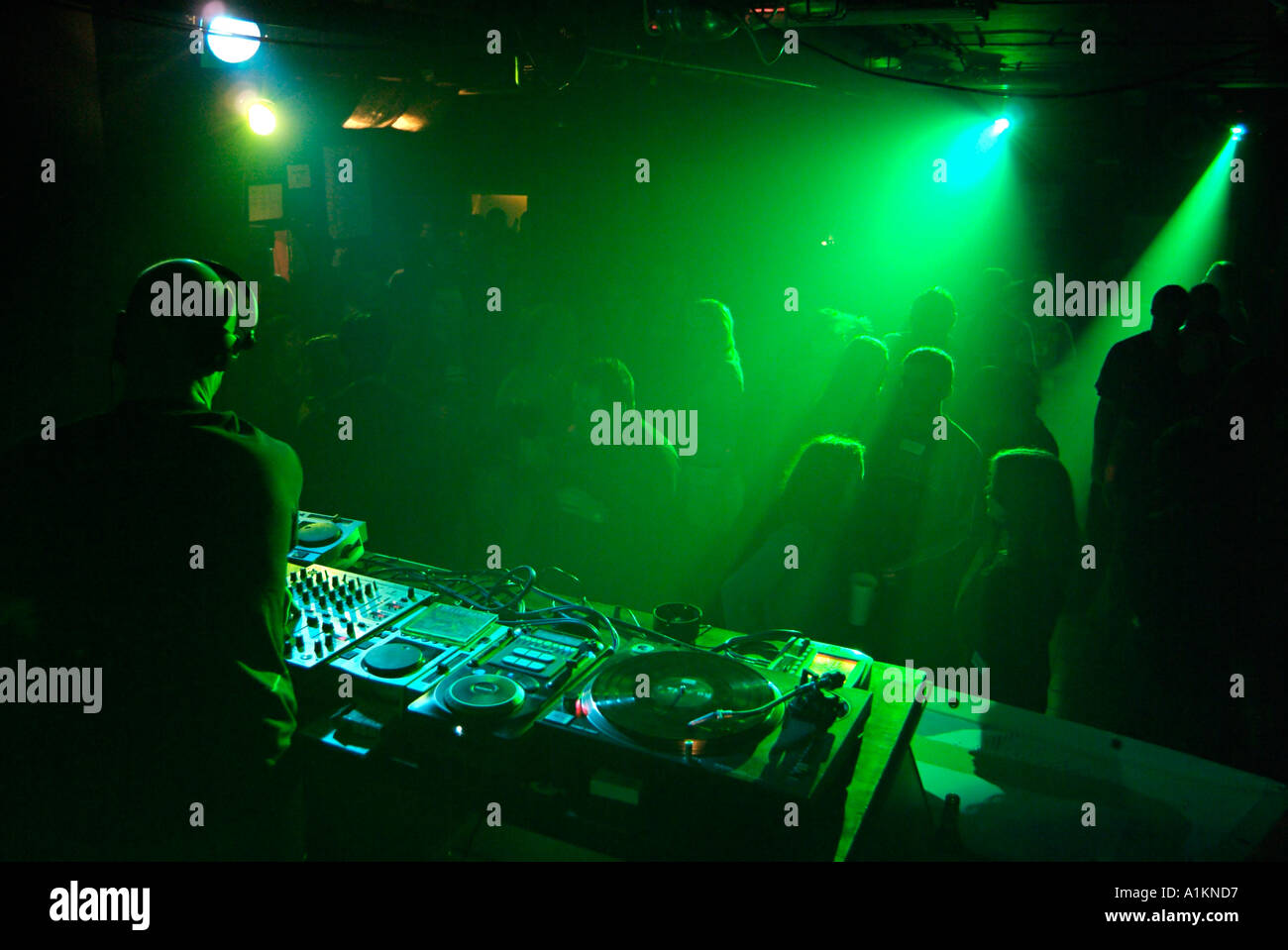 Nightclub DJ Playing a Set in a Crowded Nightspot Stock Photo - Alamy