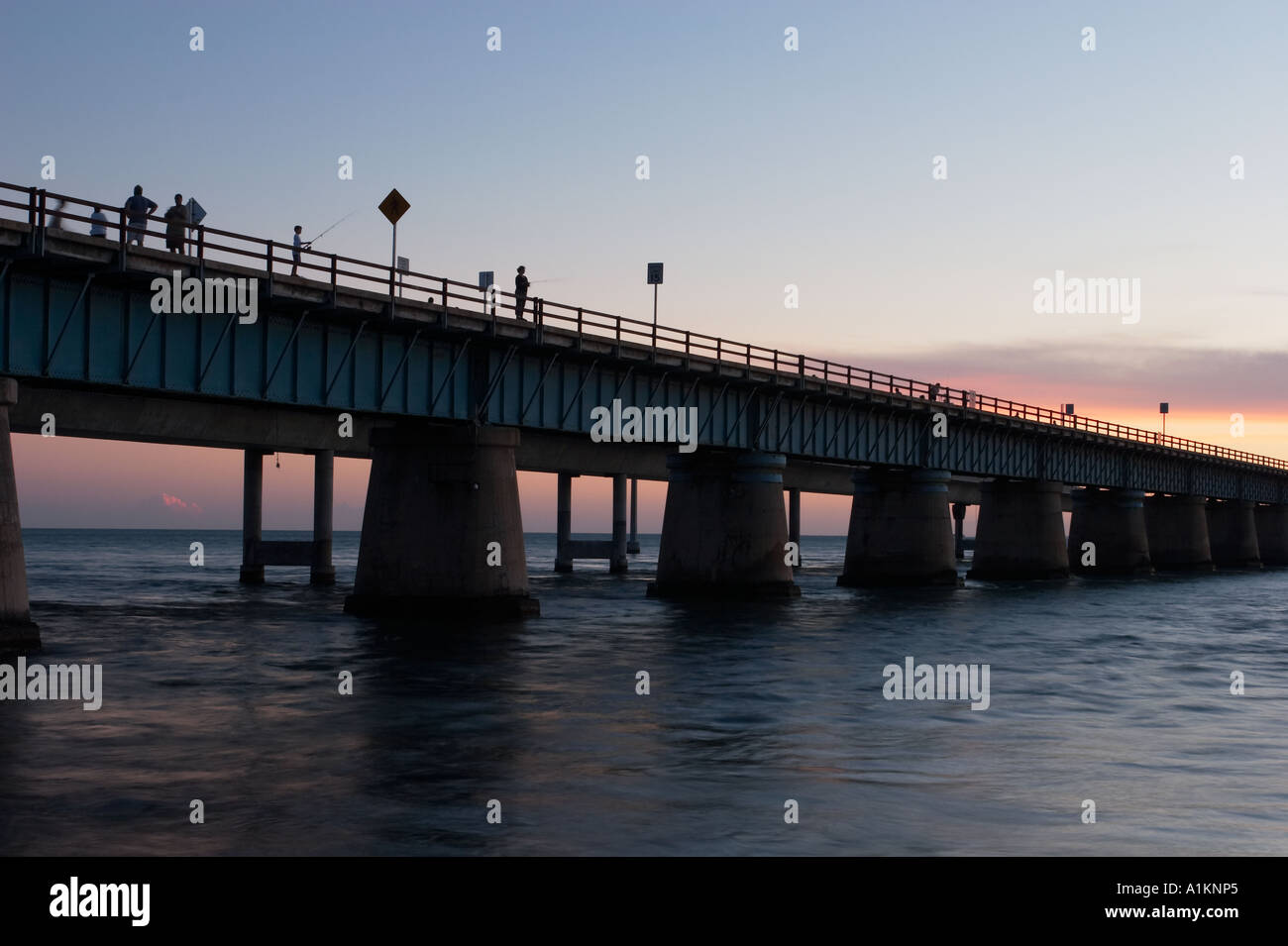 People fishing on the old Seven Mile Bridge at sunset in the Florida ...