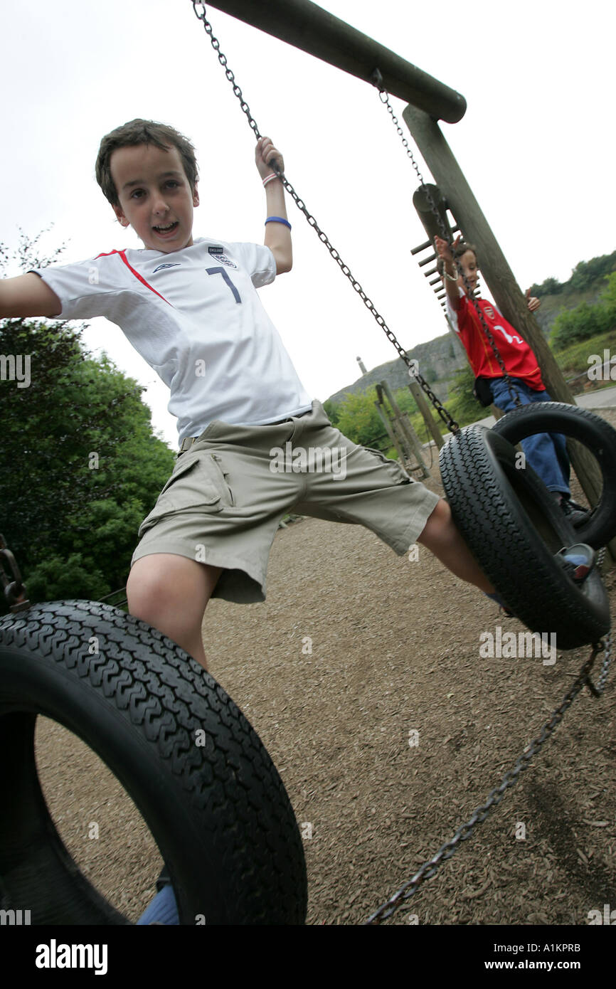 BOY ON SWING Stock Photo - Alamy