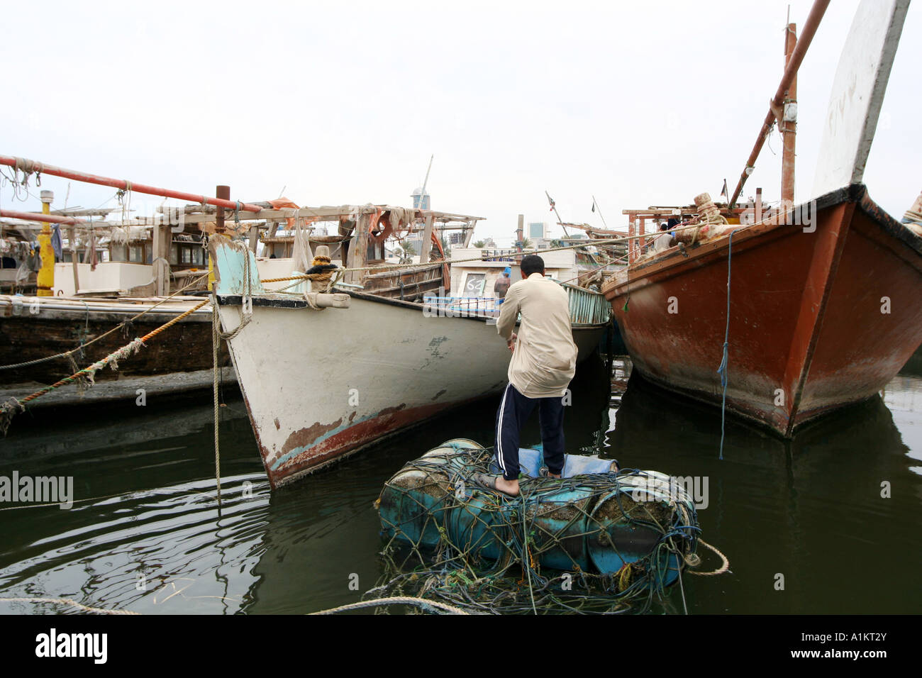 fisher man pull boat Stock Photo - Alamy