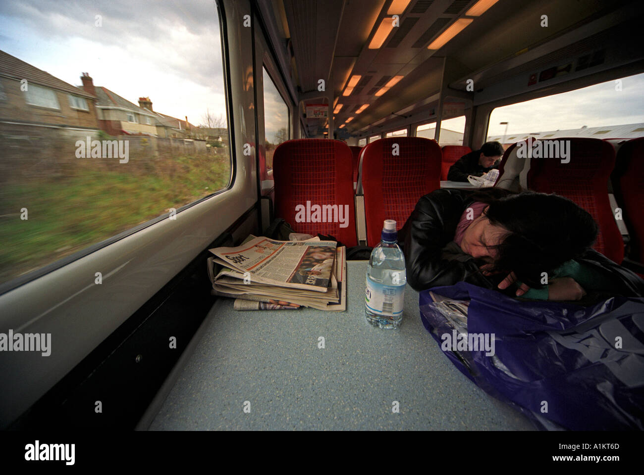 A passenger asleep on a train Stock Photo - Alamy