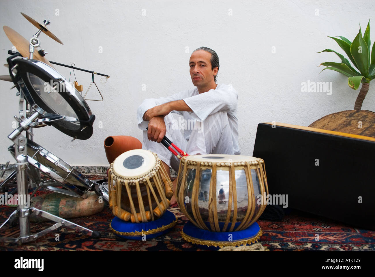 musician sits amidst his percussion instruments Stock Photo - Alamy