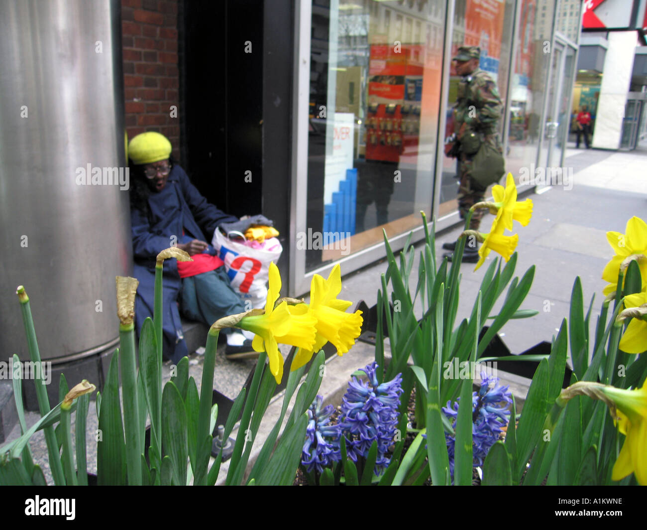 Flowers, a homeless woman and a national guardsman in NYC Stock Photo ...