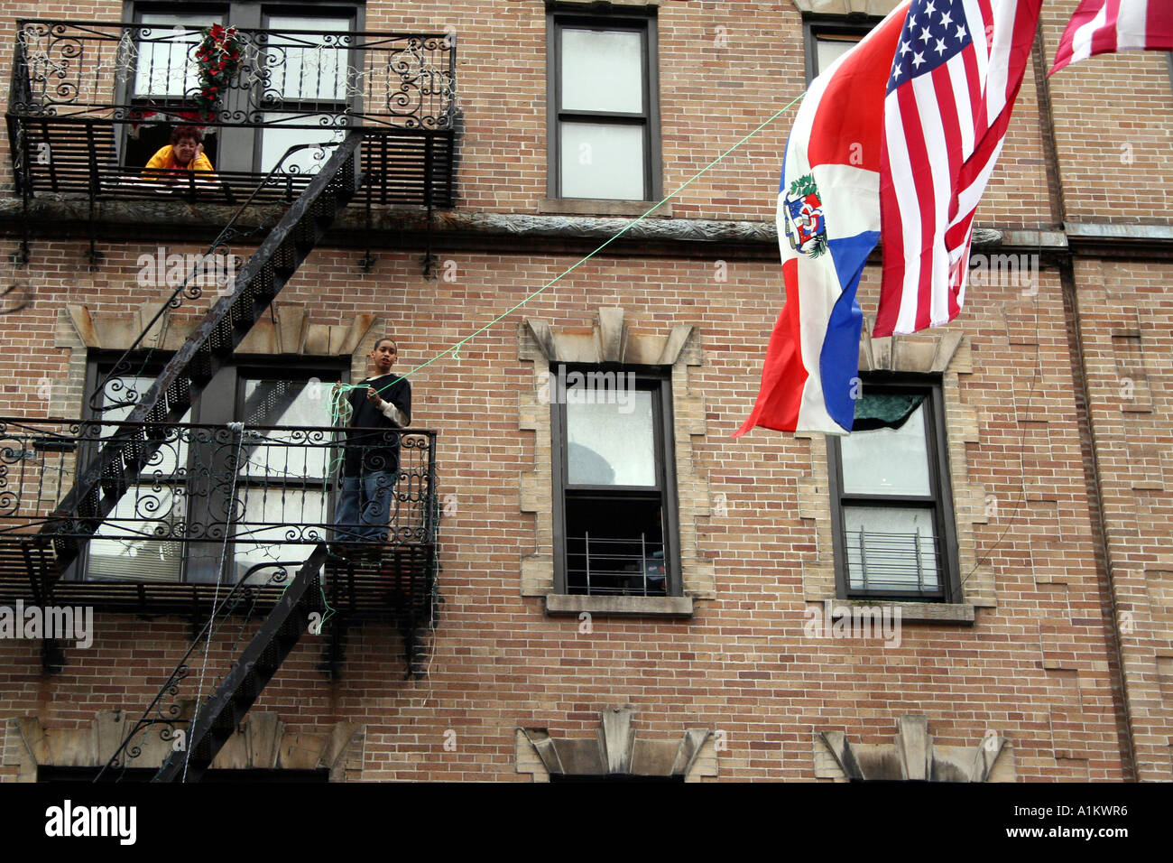 neighborhood boy pulls rope to raise country flags, NYC Stock Photo - Alamy