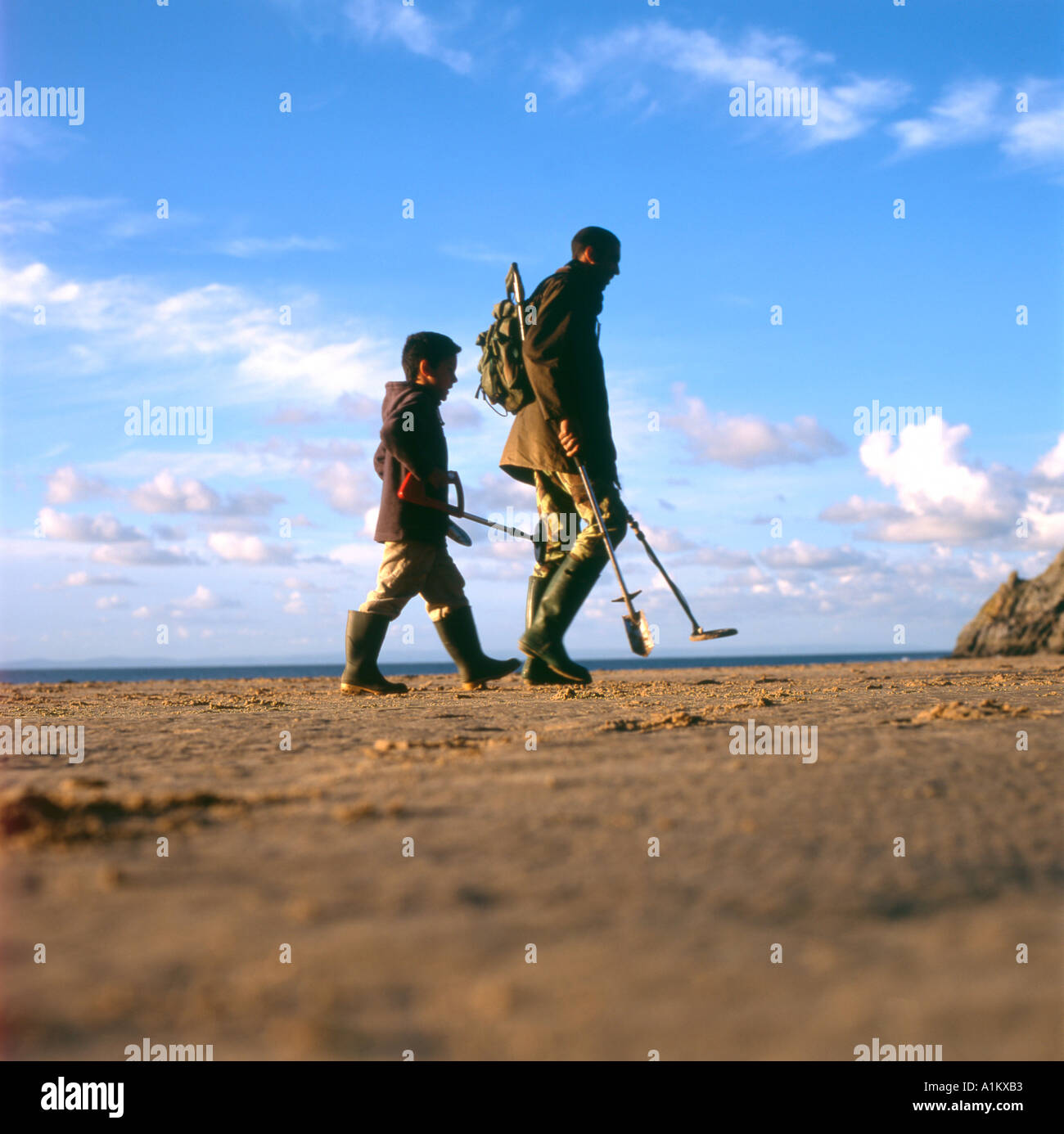 Father and son searching for treasure with metal detectors at Three ...