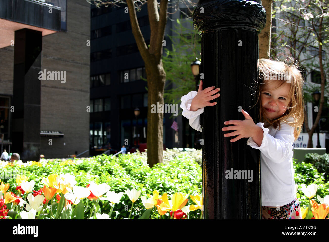 Manhattan, downtown New York City, Cute little girl hugs a lamp in ...
