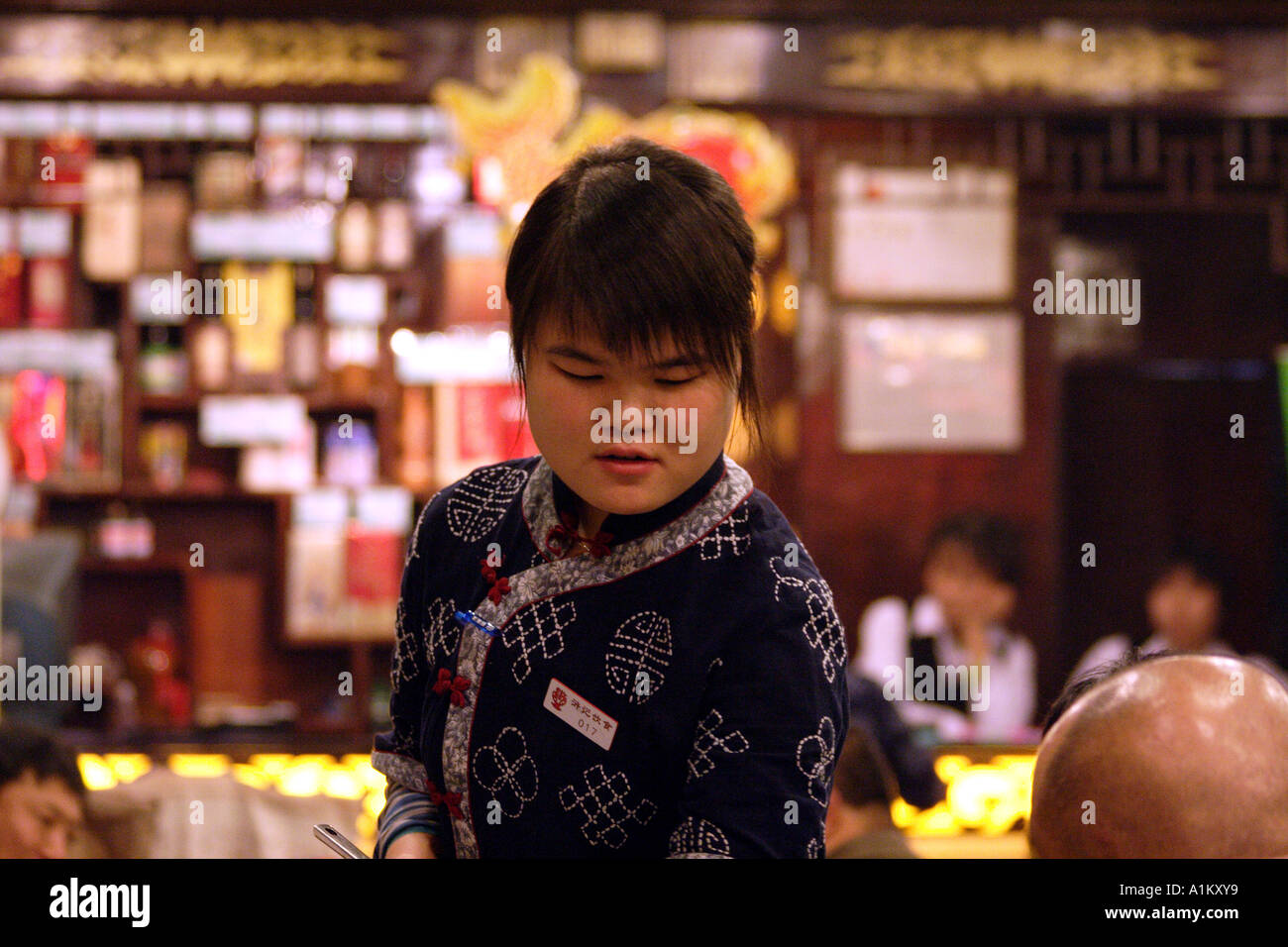 Female server at a traditional restaurant in Beijing Stock Photo - Alamy