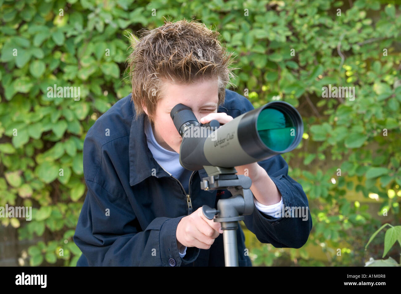 Teenage boy is birdwatching Stock Photo - Alamy