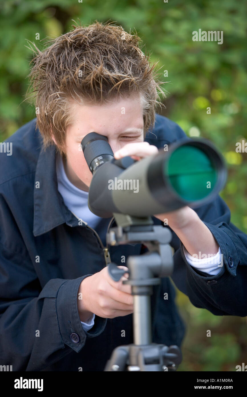 Teenage boy is birdwatching Stock Photo - Alamy