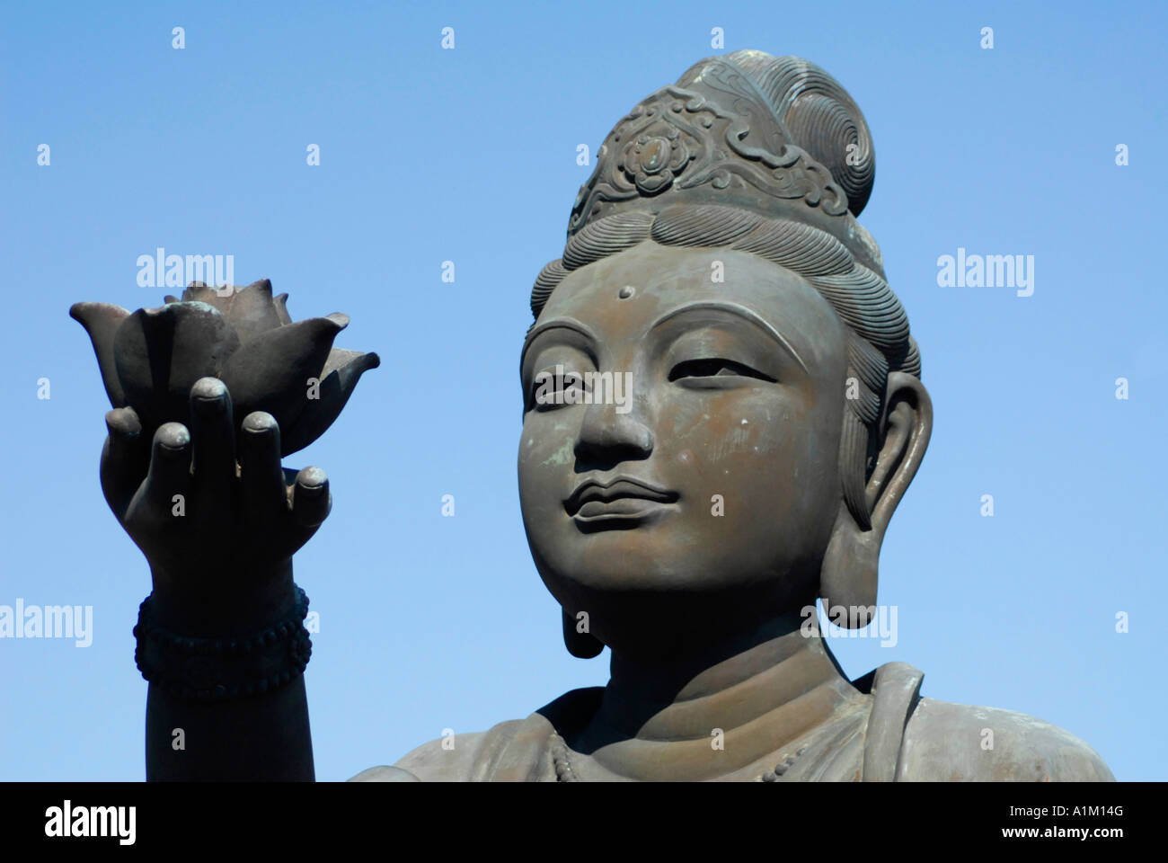 Statue of a god or immortal praising the Tian Tan giant Buddha at Ngong ...