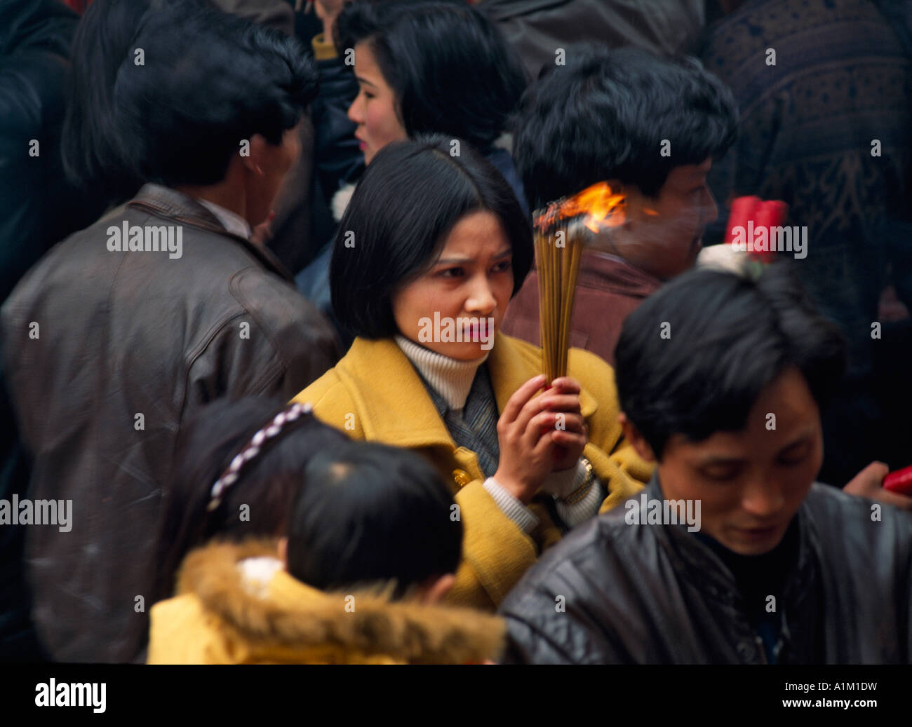 China Zhejiang Province Hangzhou modern pilgrims praying in the temple ...