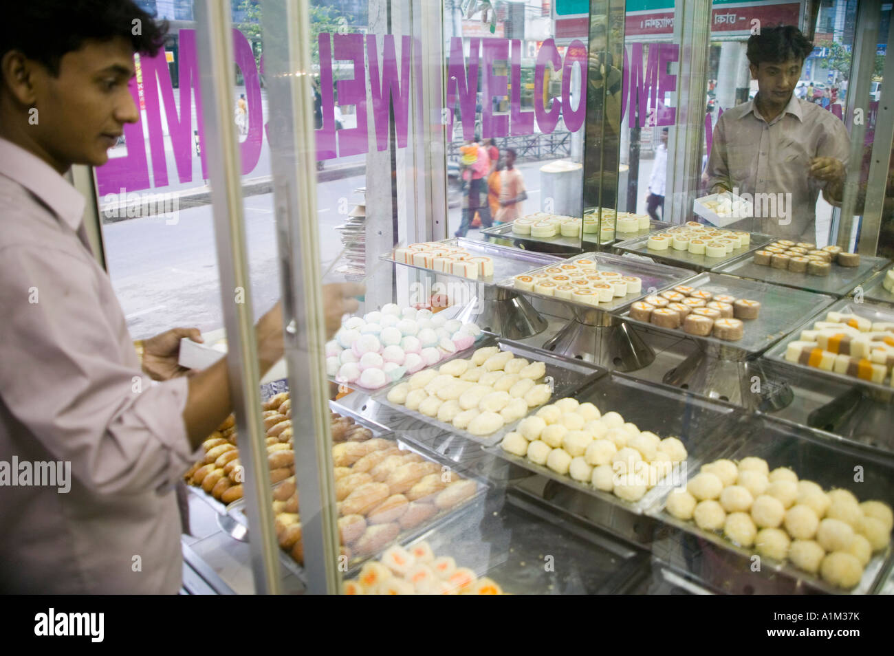 Man selecting sweets from a bakery in Dhaka Bangladesh Stock Photo - Alamy