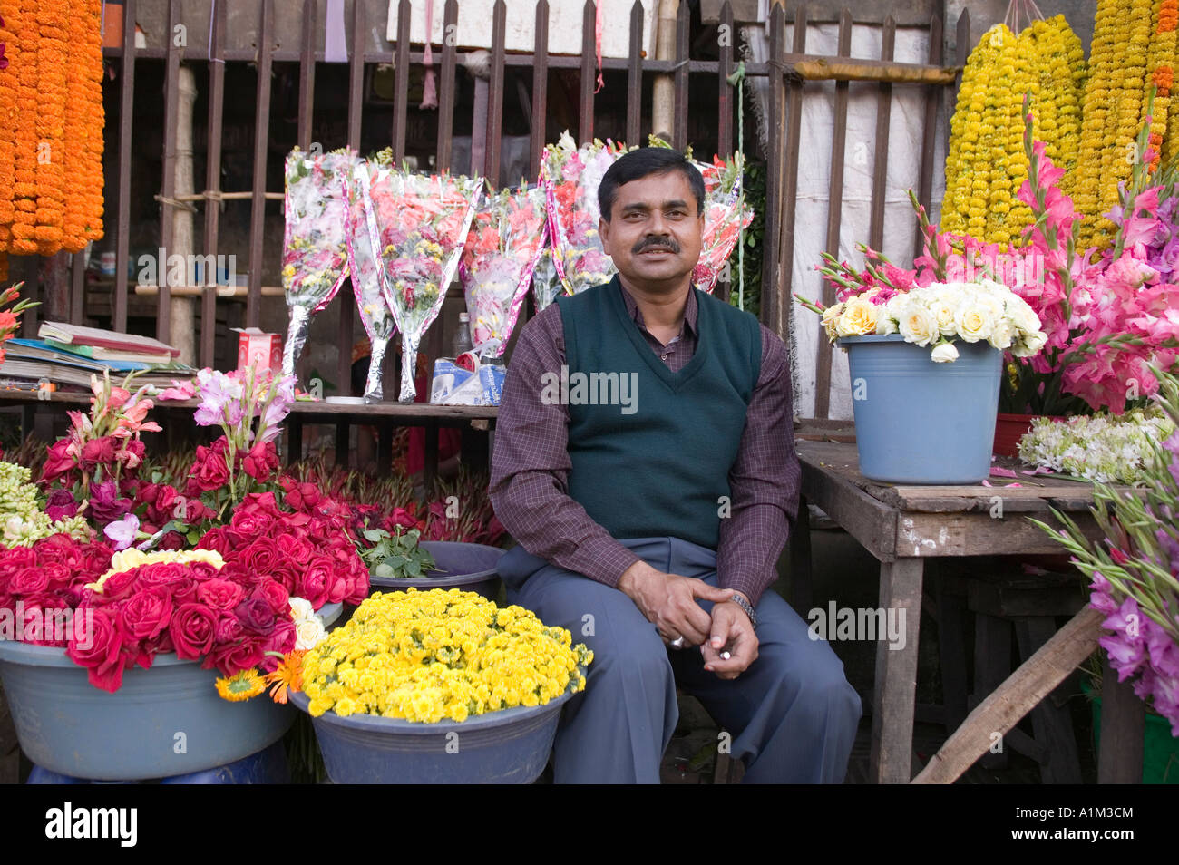 Flower vendor at his stall in the flower market in Dhaka Bangladesh ...