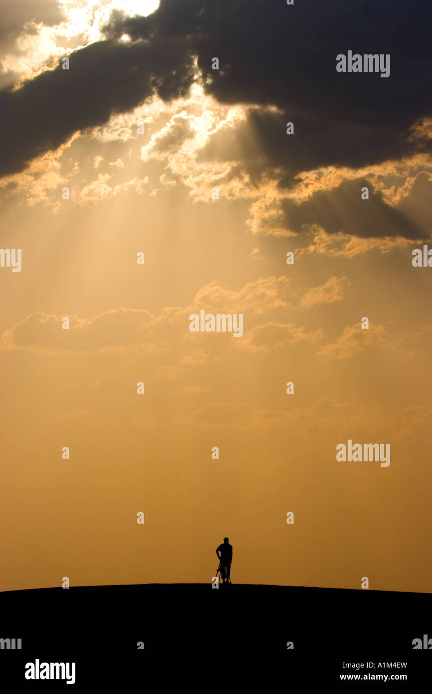 Standing watching the setting sun Stock Photo - Alamy