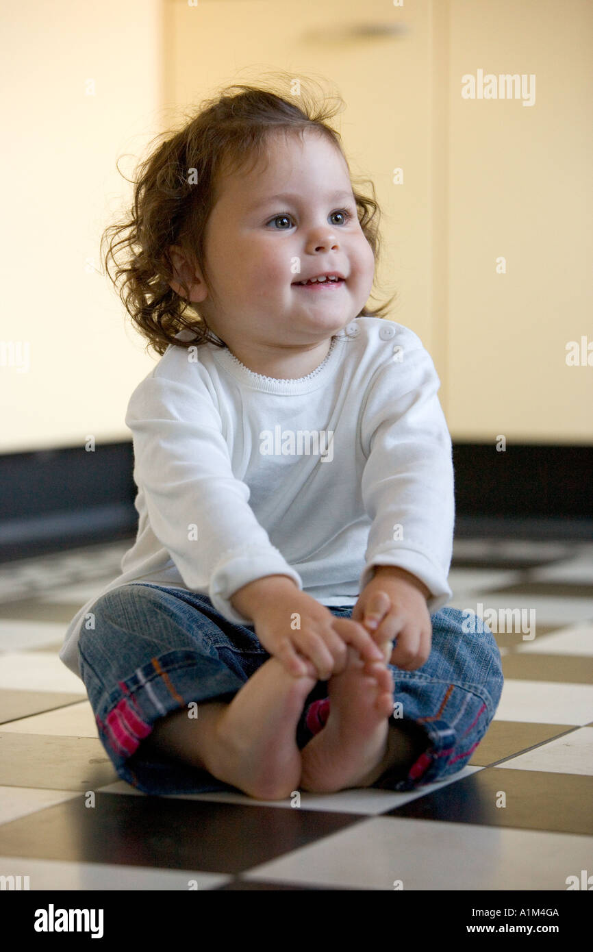 Little child is sitting on the floor Stock Photo - Alamy