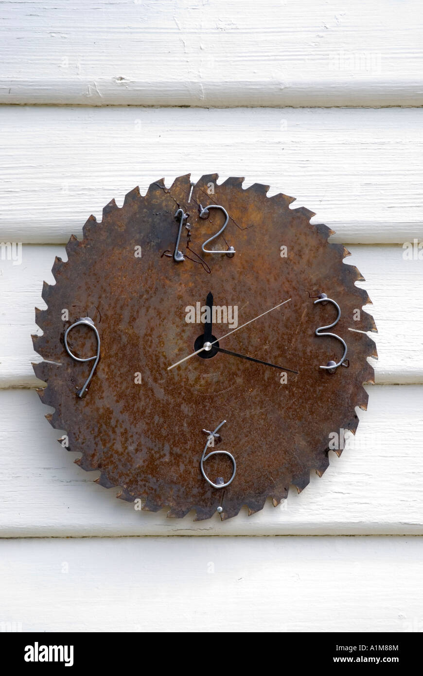 Outdoor garden clock made from a circular saw blade Stock Photo - Alamy