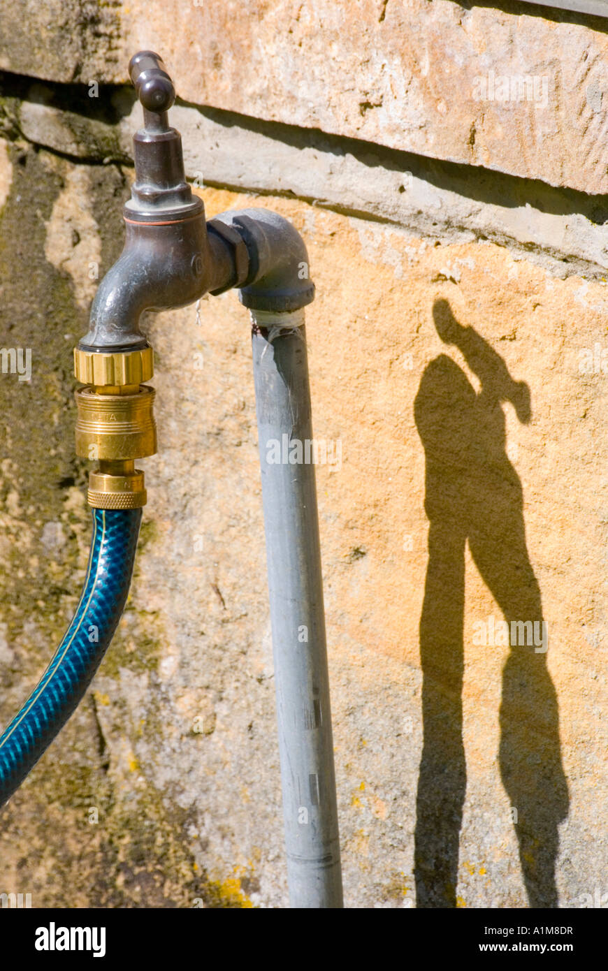 Brass tap and connected hose Stock Photo - Alamy