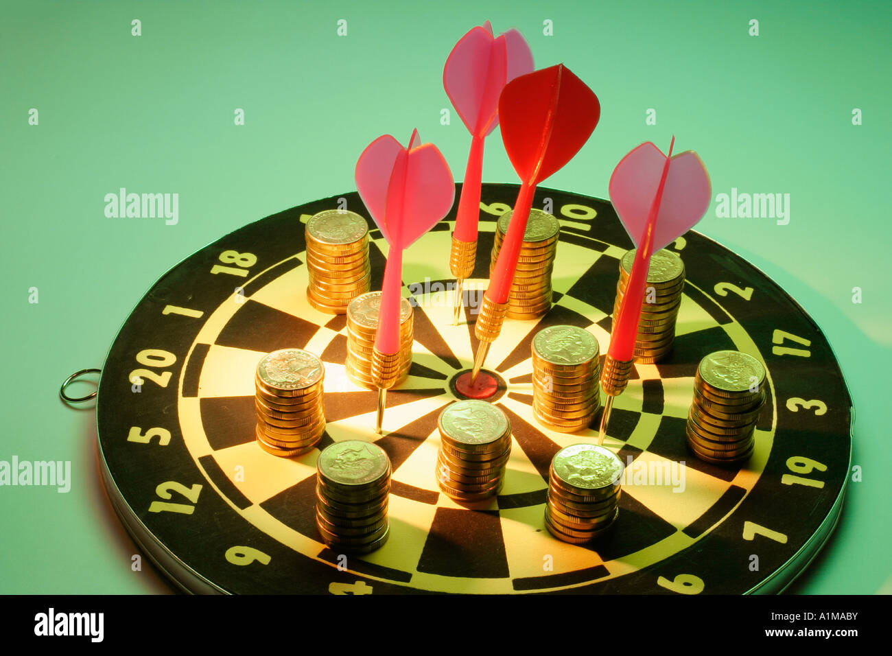 Darts and Coins on Dartboard Stock Photo - Alamy