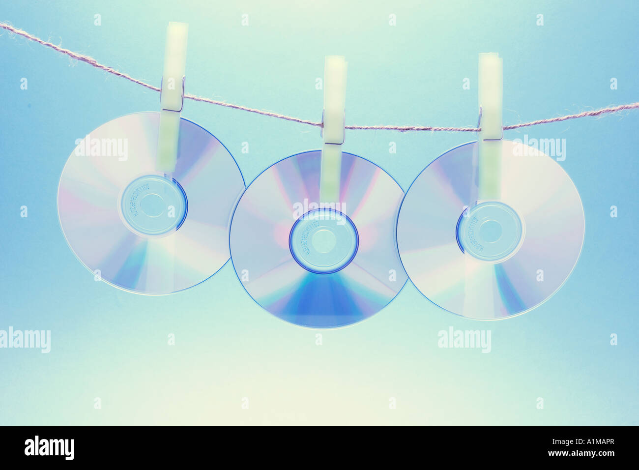 CDs Hanging on String with Clothes Pegs Stock Photo - Alamy