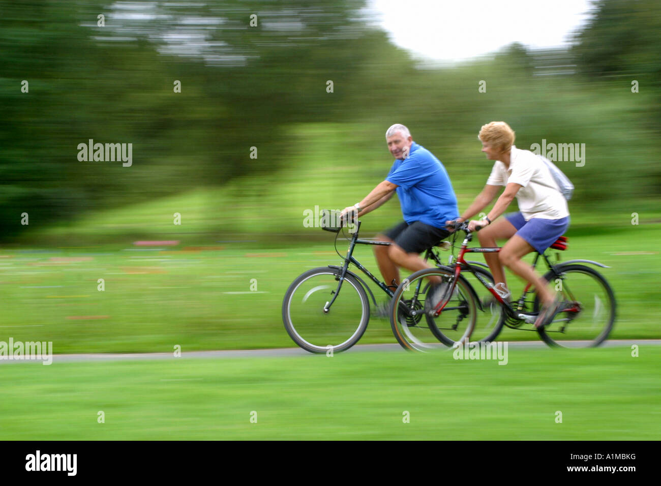 Cyclists using a cycle path in a park setting Stock Photo - Alamy