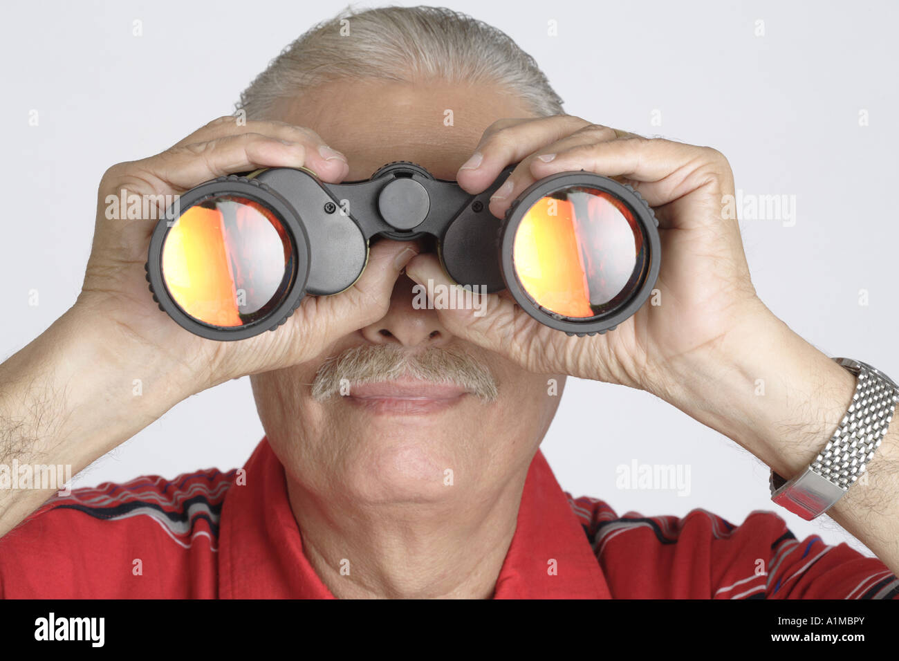 Old Indian senior citizen man looking through binoculars - MR# Stock ...