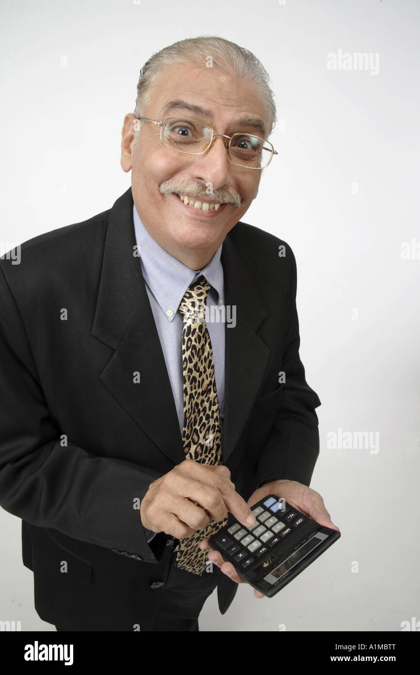 Senior citizen working on calculator wearing business suit Stock Photo ...