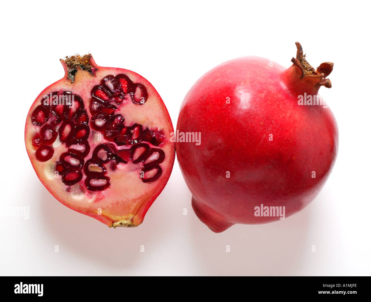 Whole and half pomegranate Stock Photo - Alamy