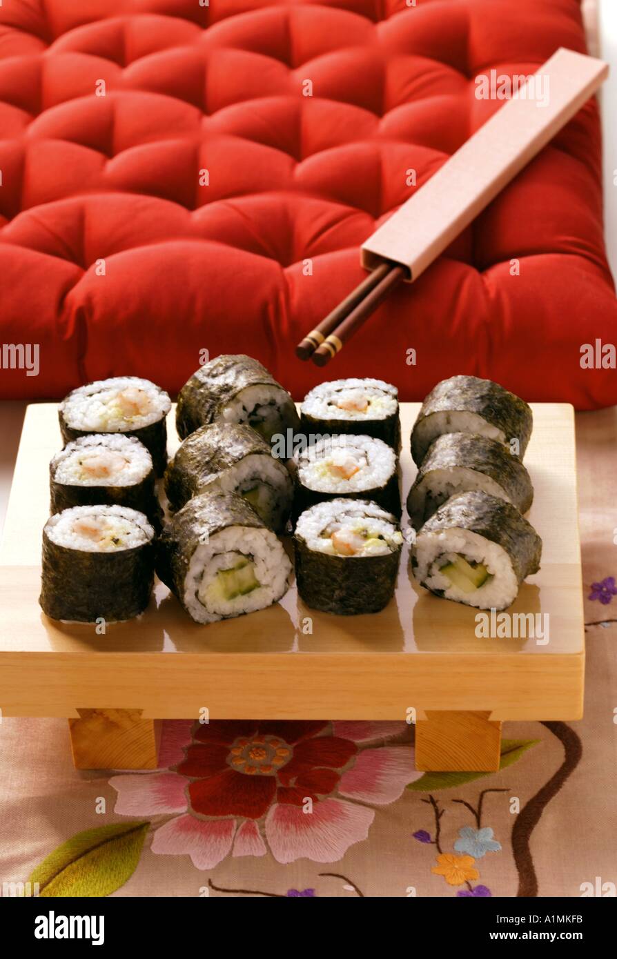 Maki sushi platter in front of red cushion Stock Photo - Alamy