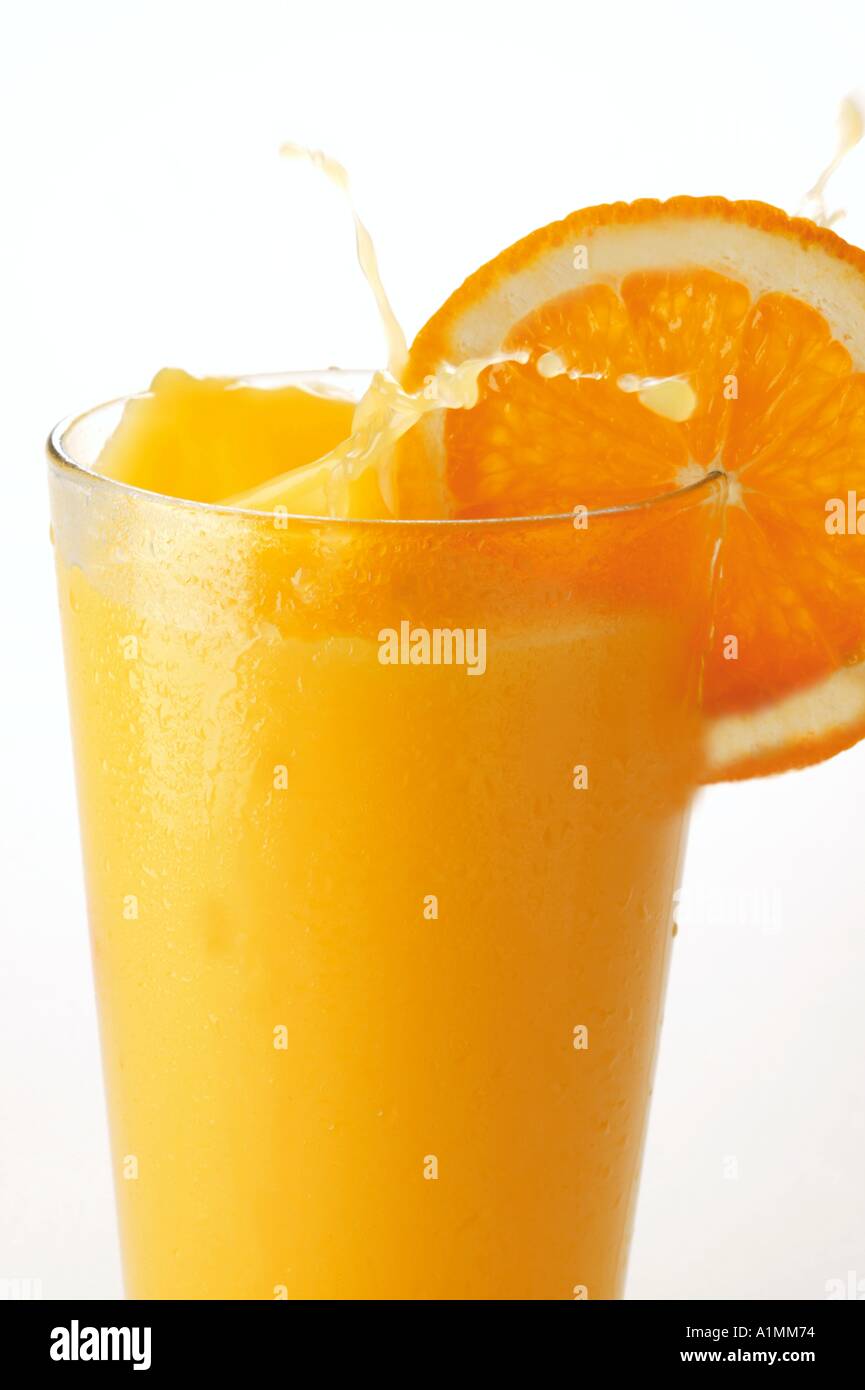 Orange juice splashing out of glass 2 Stock Photo - Alamy