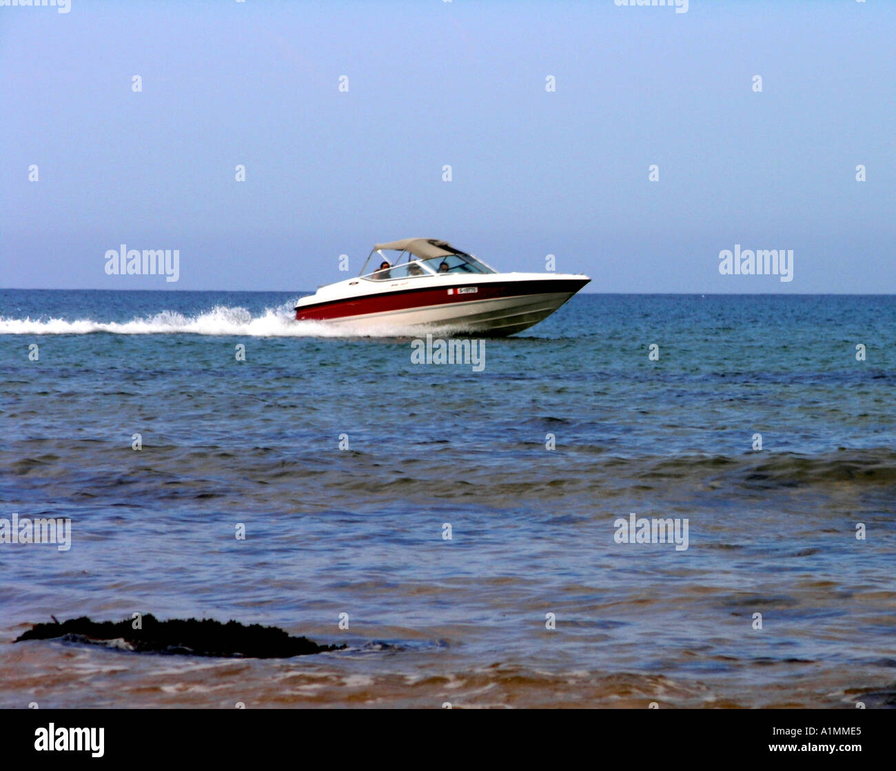 Speedboat close to shore Stock Photo - Alamy