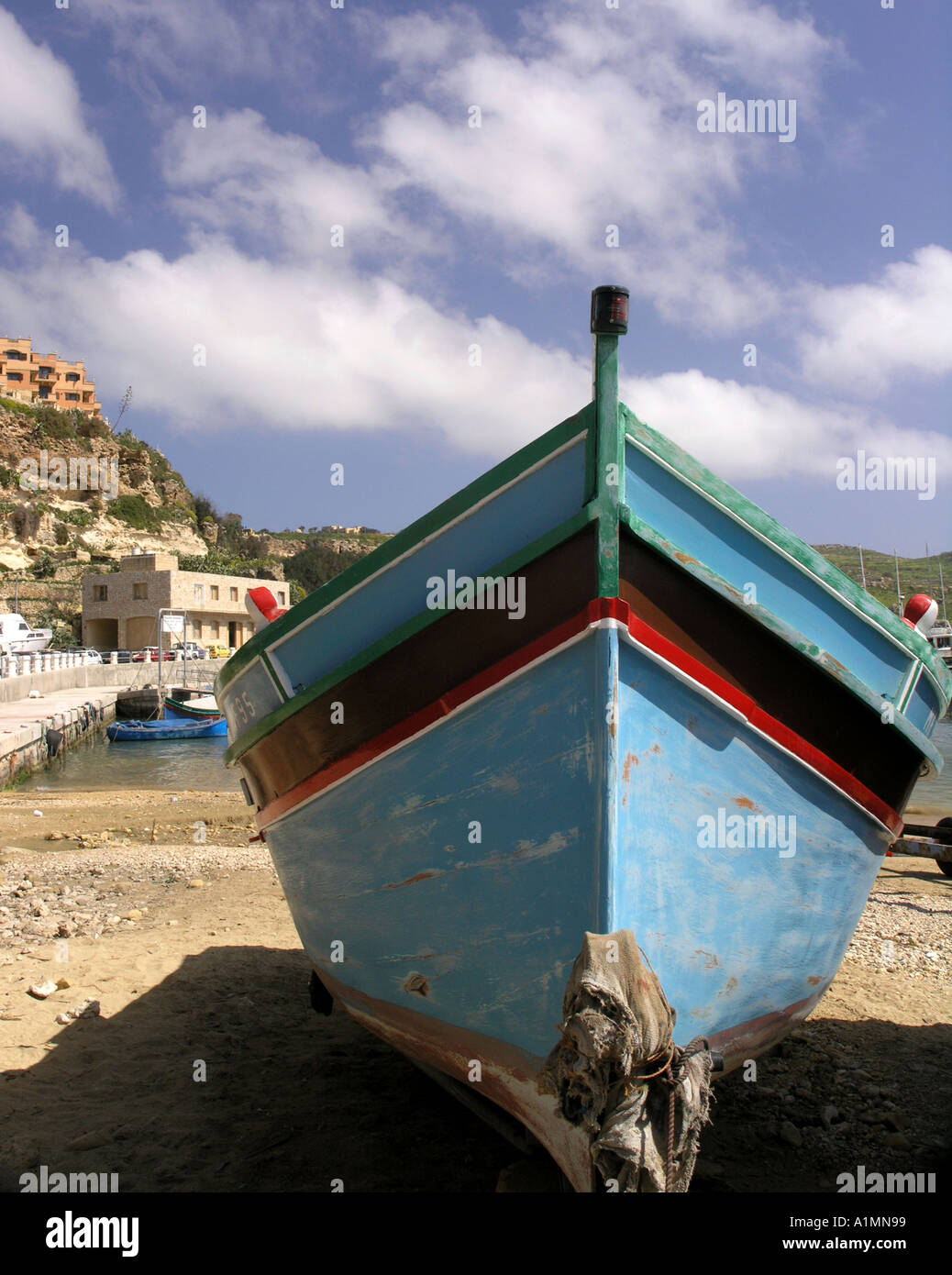 Maltese Luzzu traditional fishing boat on a beach Gozo Malta Stock ...