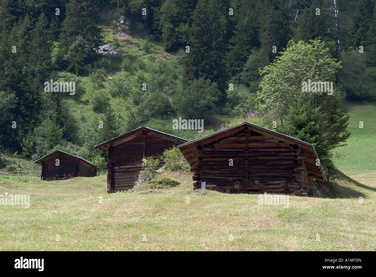 Three Swiss barns Stock Photo - Alamy