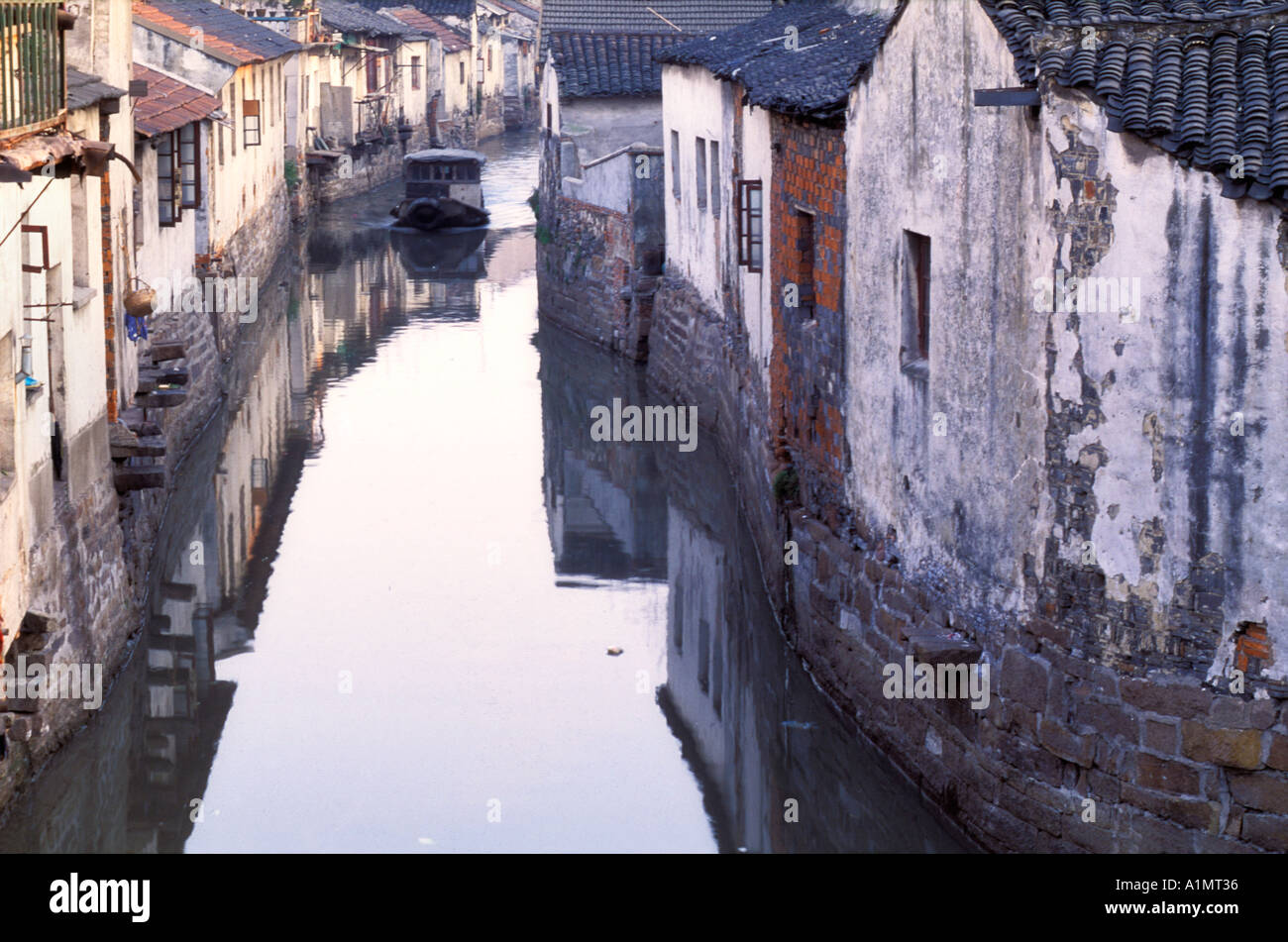 Traditional architecture with stone bridge and boats on the Grand Canal ...