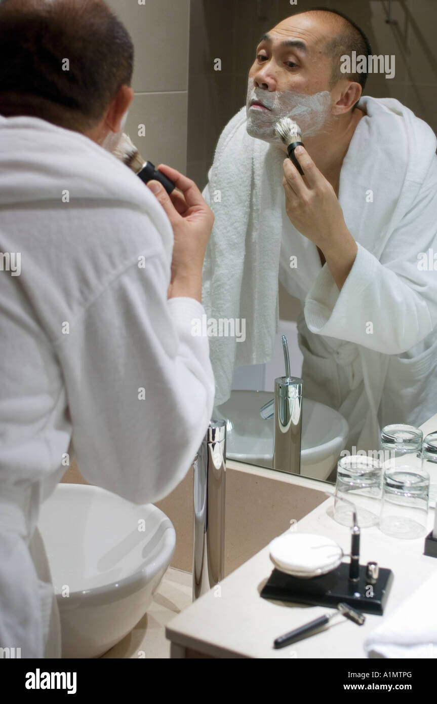 Middle-aged man shaving Stock Photo - Alamy