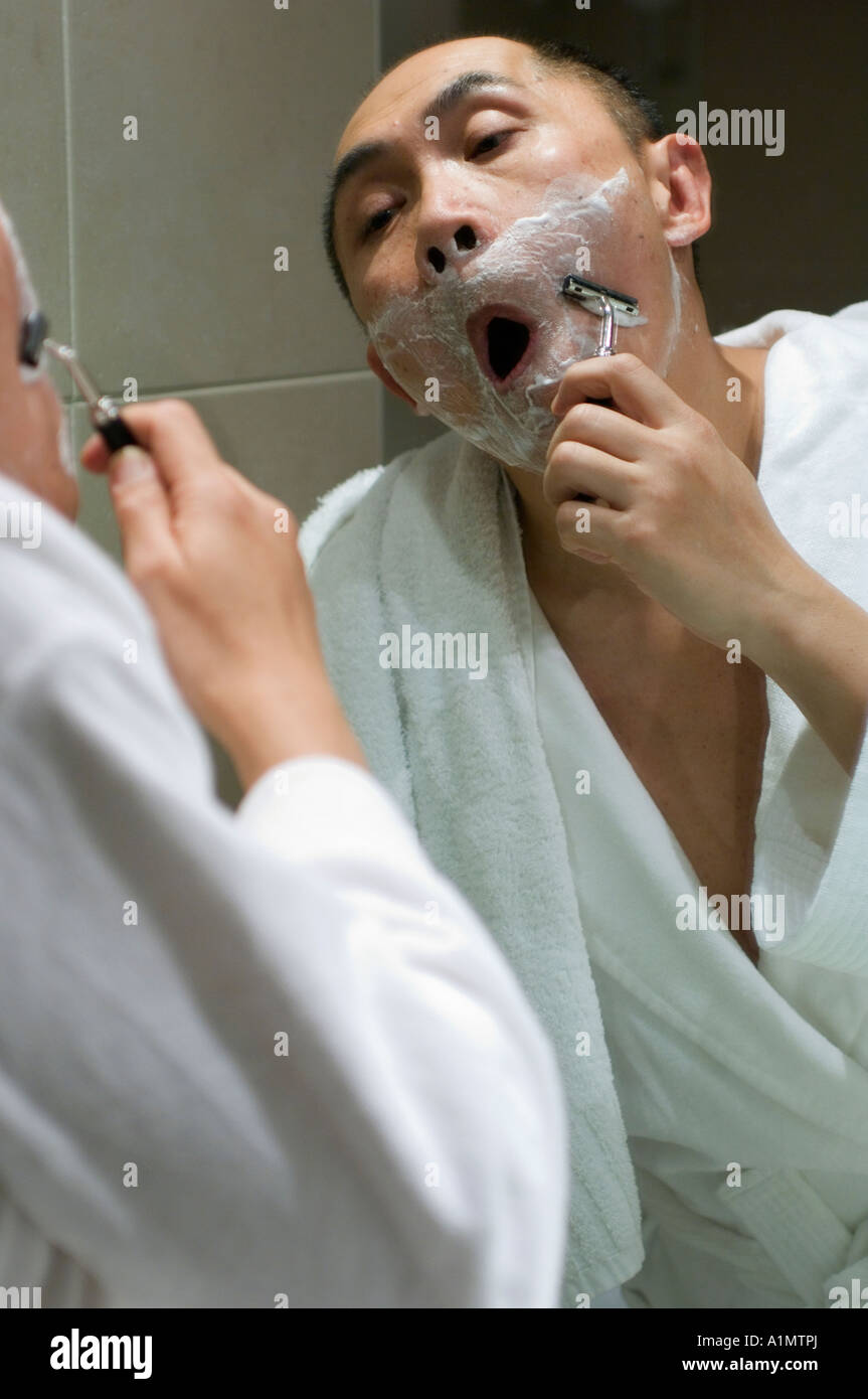 Middle-aged man shaving Stock Photo - Alamy