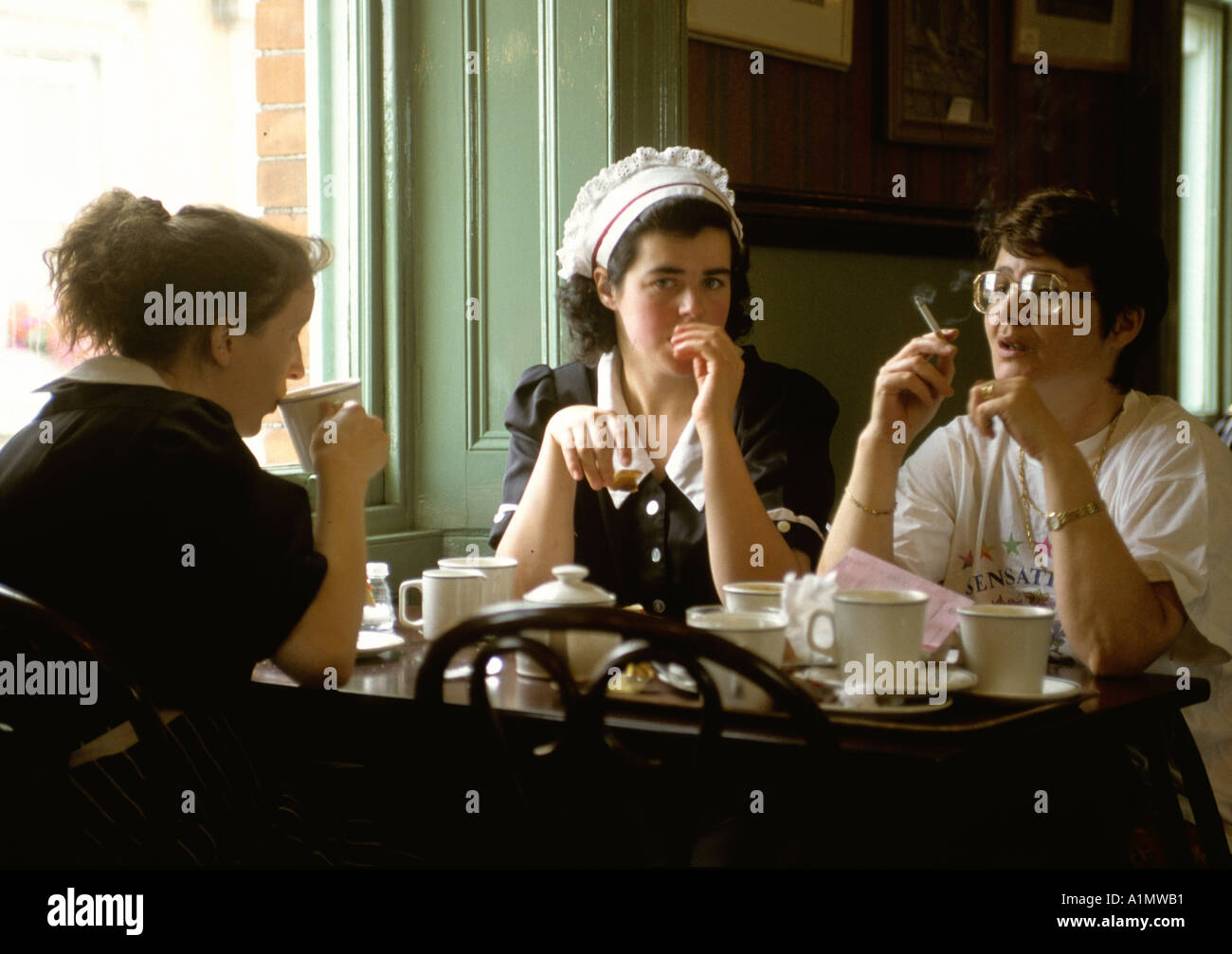 A waitress with friends takes a break at Bewlys Cafe in Ennis Co Clare ...